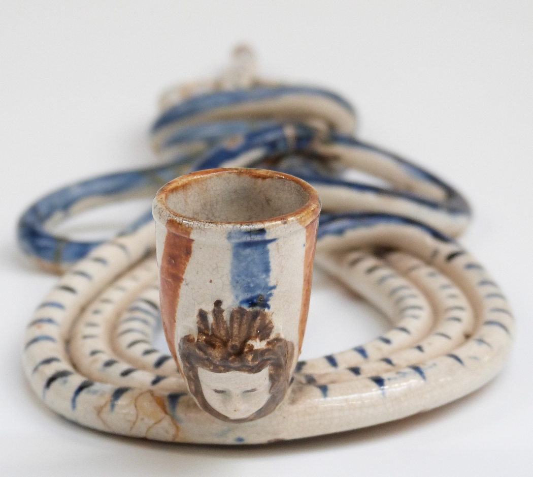 Prattware early 19thC puzzle pipe with mask decoration, L27cm
