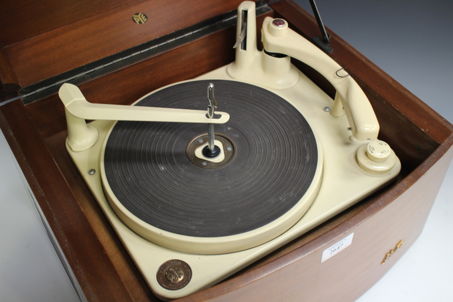 A Pye 'Monarch' walnut cased table top record player with cream ...