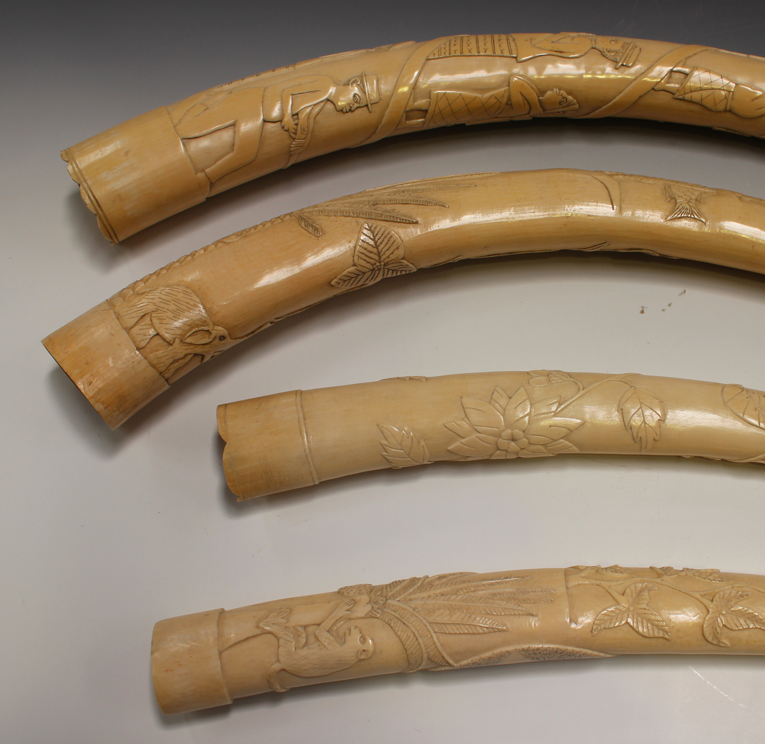 An early 20th century African fully-carved ivory tusk, worked in ...