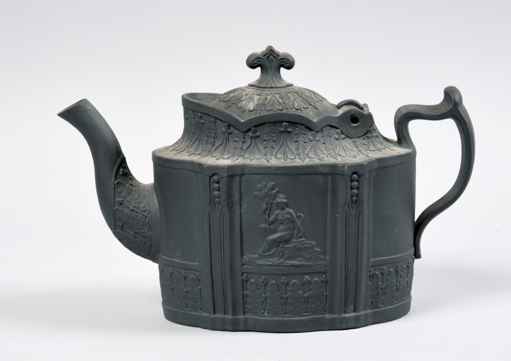 An early 19c black basalt teapot moulded with classical figure and ...