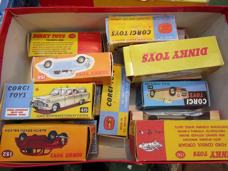 A collection of Dinky and Corgi diecast cars in reproduction boxes