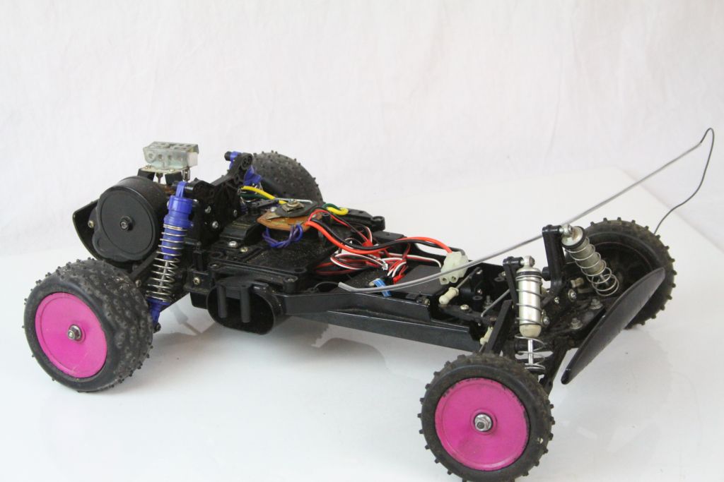 Six early Tamiya remote control car chassis.