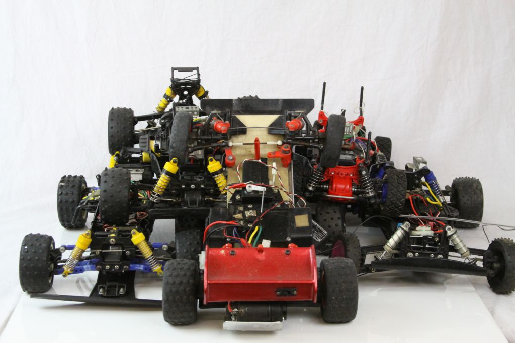 Six early Tamiya remote control car chassis.