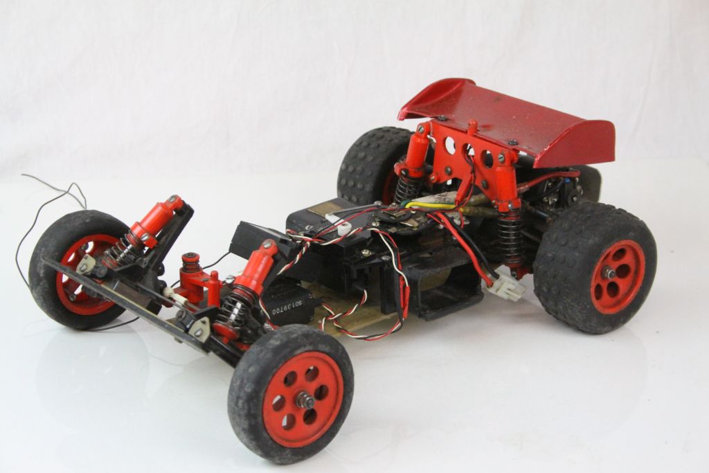 Six early Tamiya remote control car chassis.