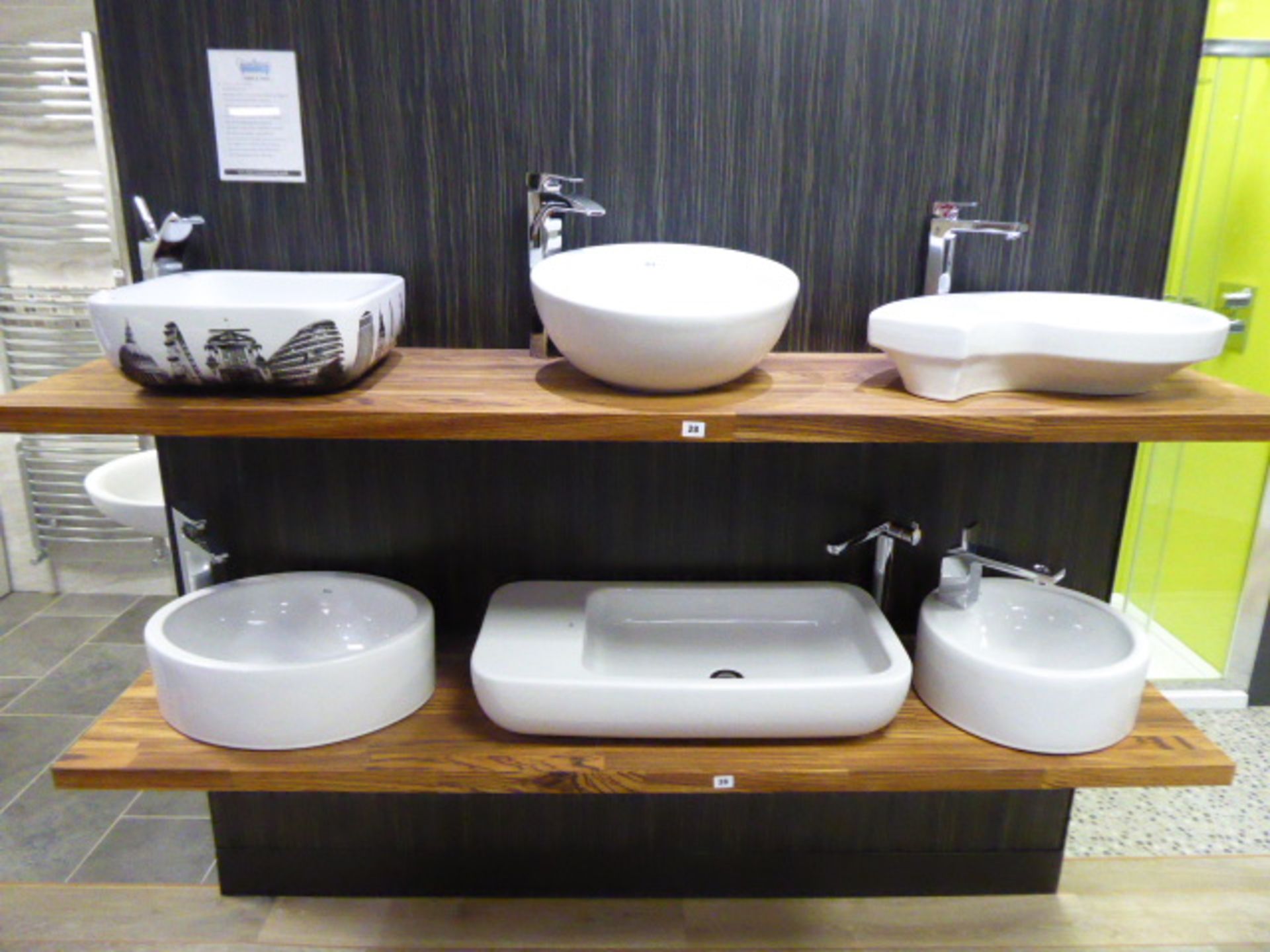 Display of 6 Roca hand basins with assorted tap sets