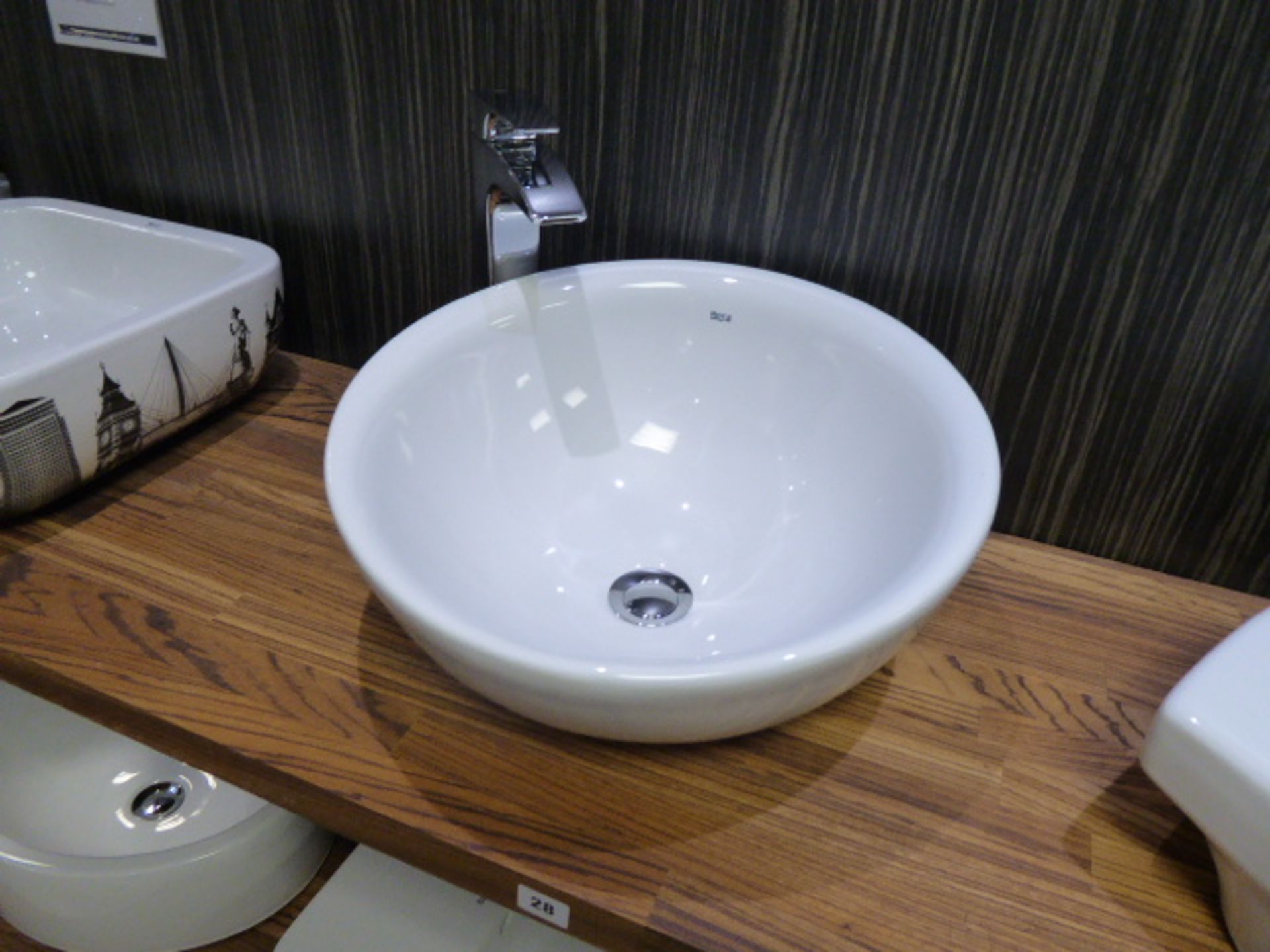 Display of 6 Roca hand basins with assorted tap sets