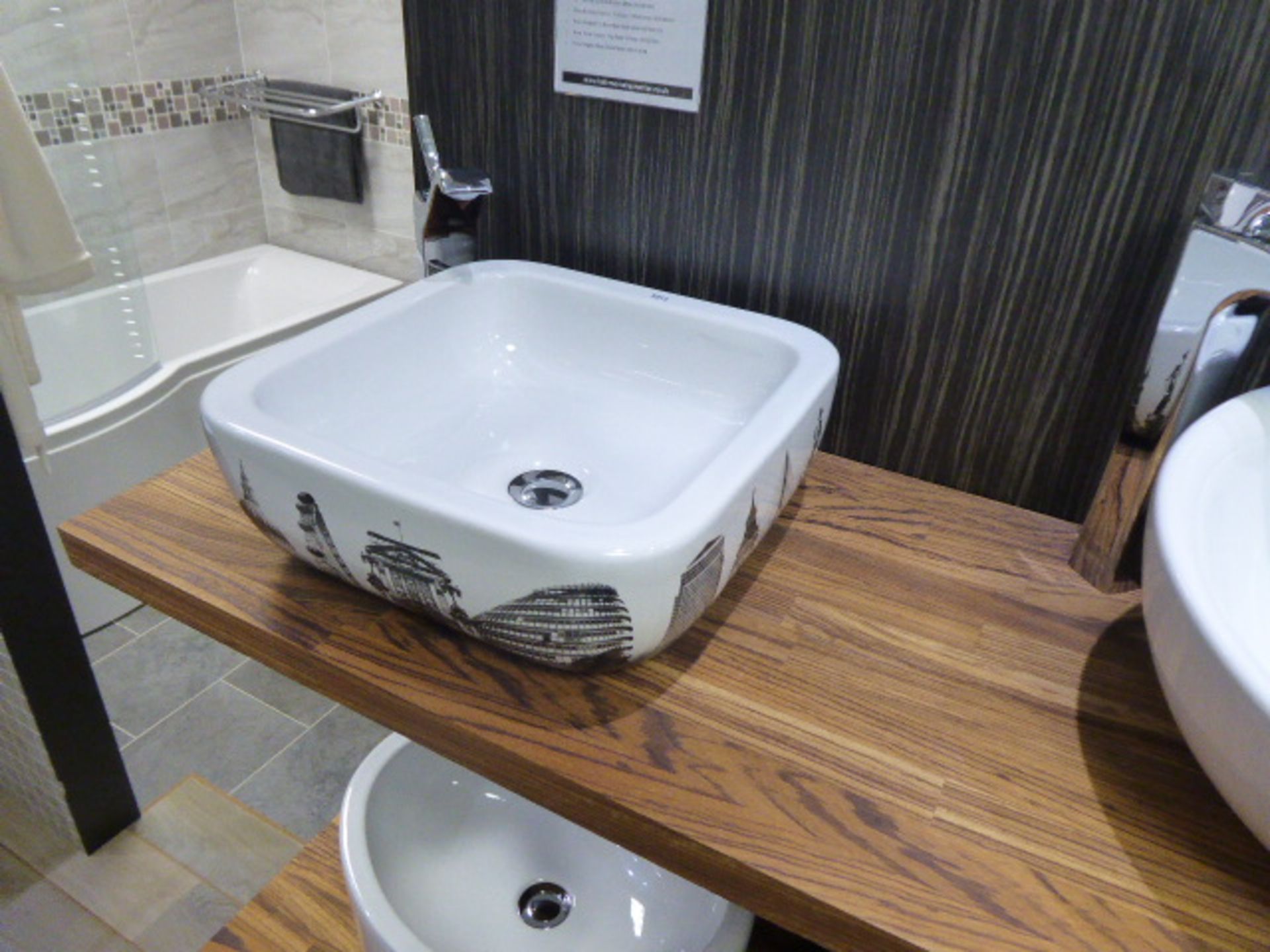 Display of 6 Roca hand basins with assorted tap sets