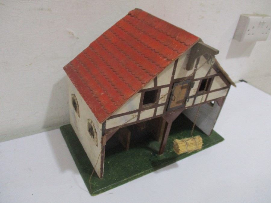 A wooden and card Elastolin stable with two cart horses, hay manger ...