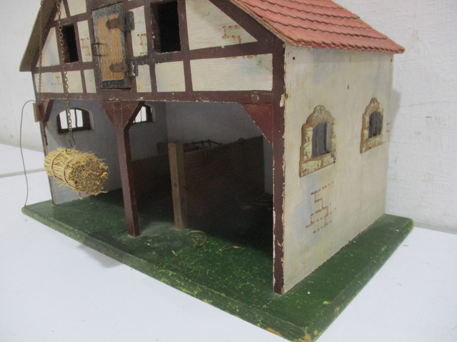 A wooden and card Elastolin stable with two cart horses, hay manger ...