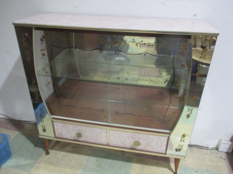 A kitsch mid century display cabinet with mirrored back