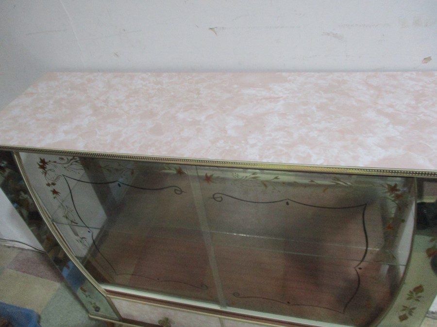 A kitsch mid century display cabinet with mirrored back