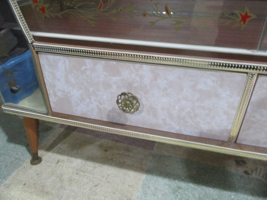 A kitsch mid century display cabinet with mirrored back
