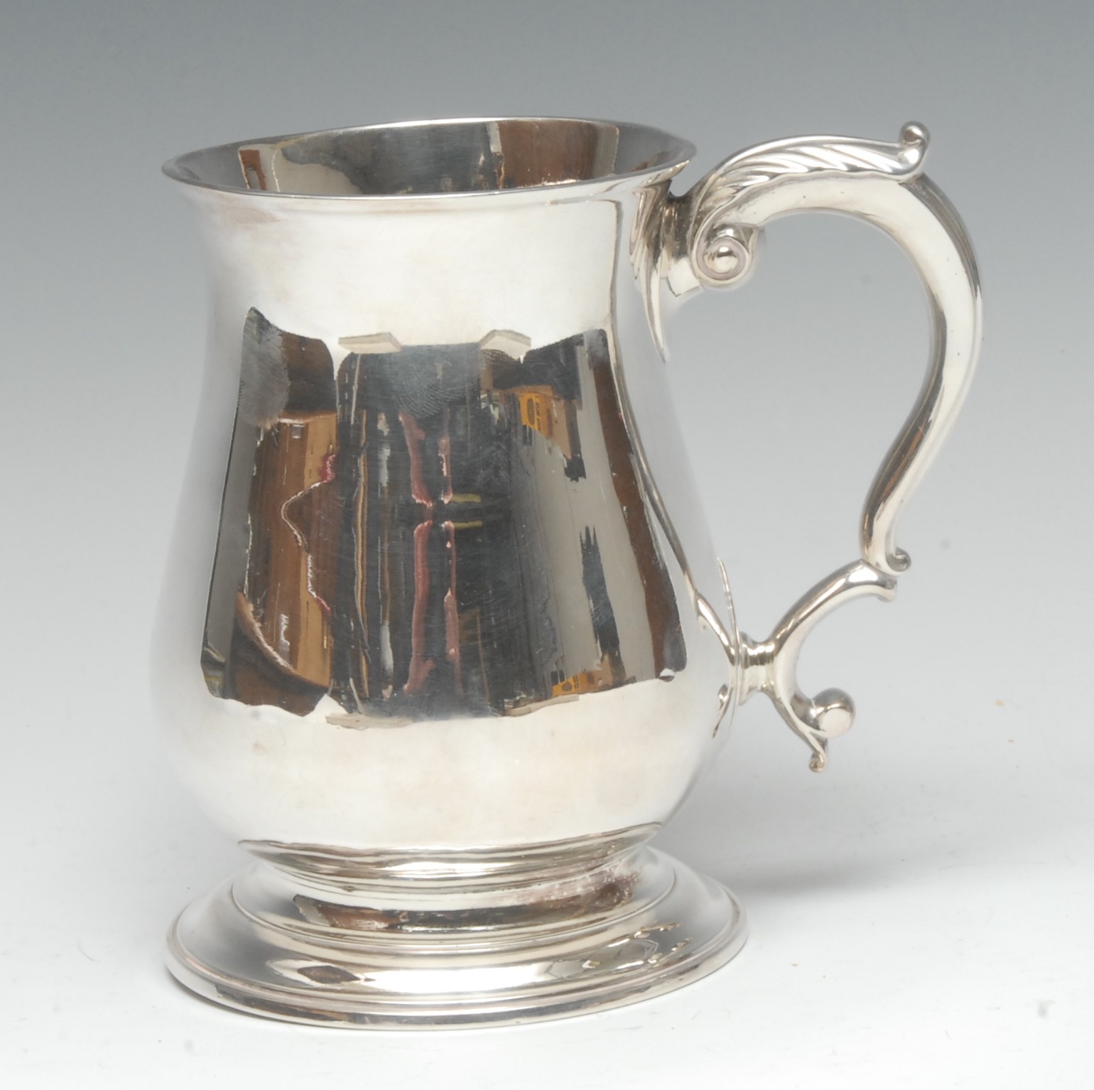 A George II silver bell shaped mug, quite plain, flared rim, acanthus ...