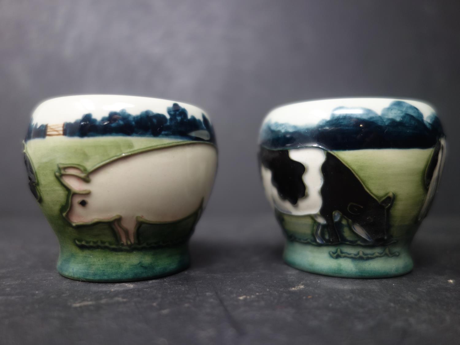 A boxed set of 6 Moorcroft egg cups, with farmyard animal design, by ...