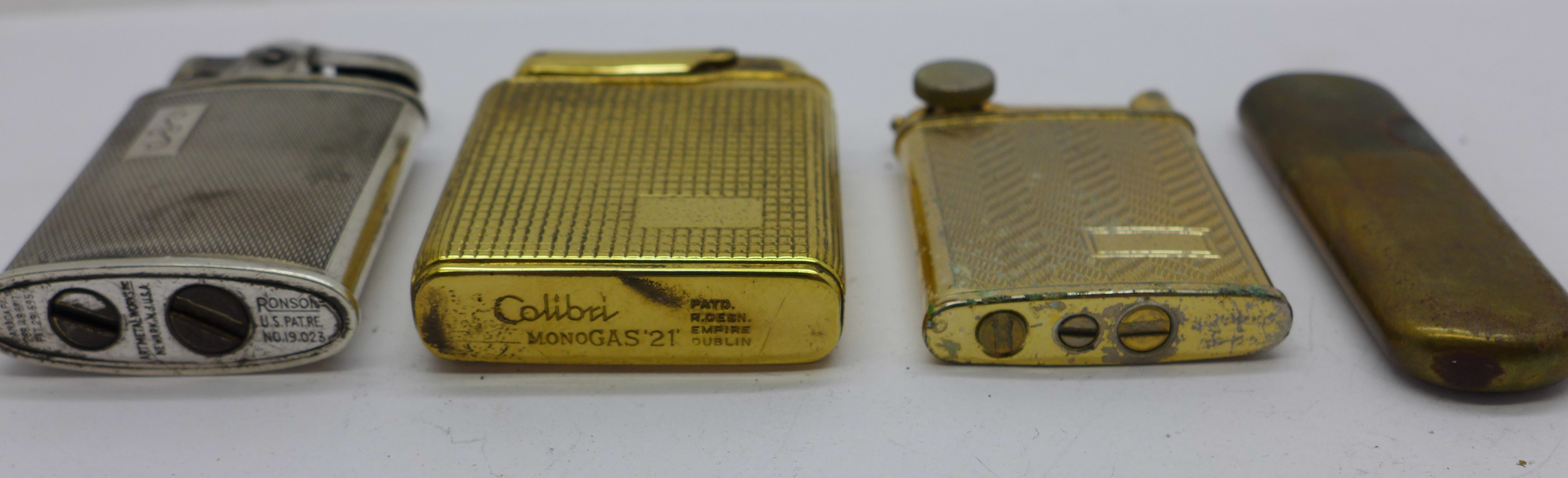 A silver lighter and three other lighters