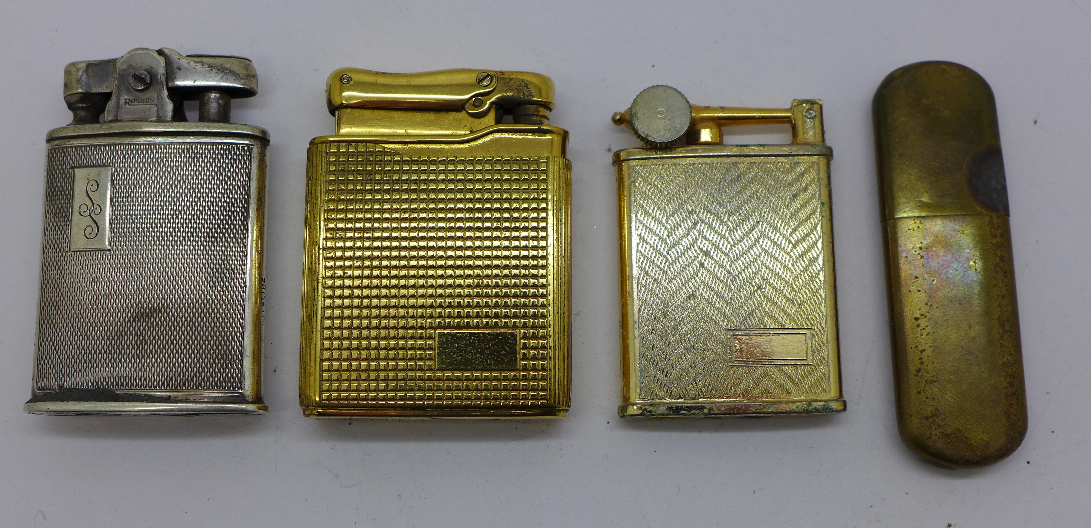 A silver lighter and three other lighters