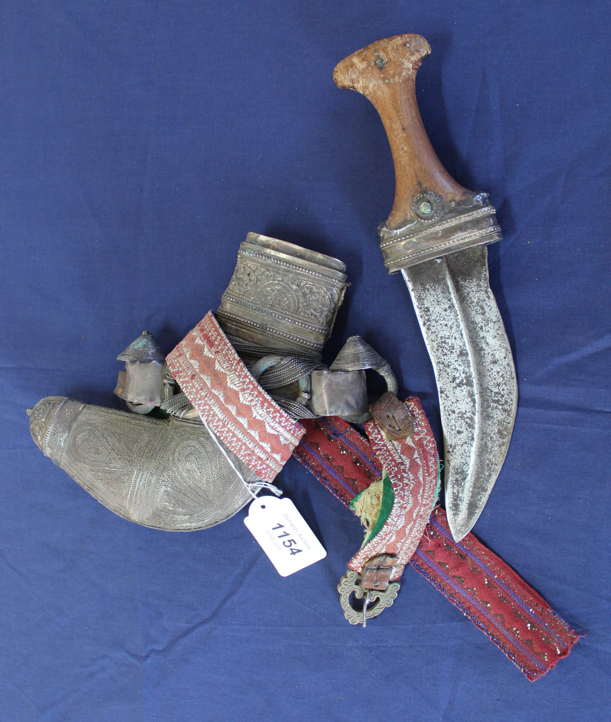 A Middle Eastern Jambiya dagger with sheath and braid belt