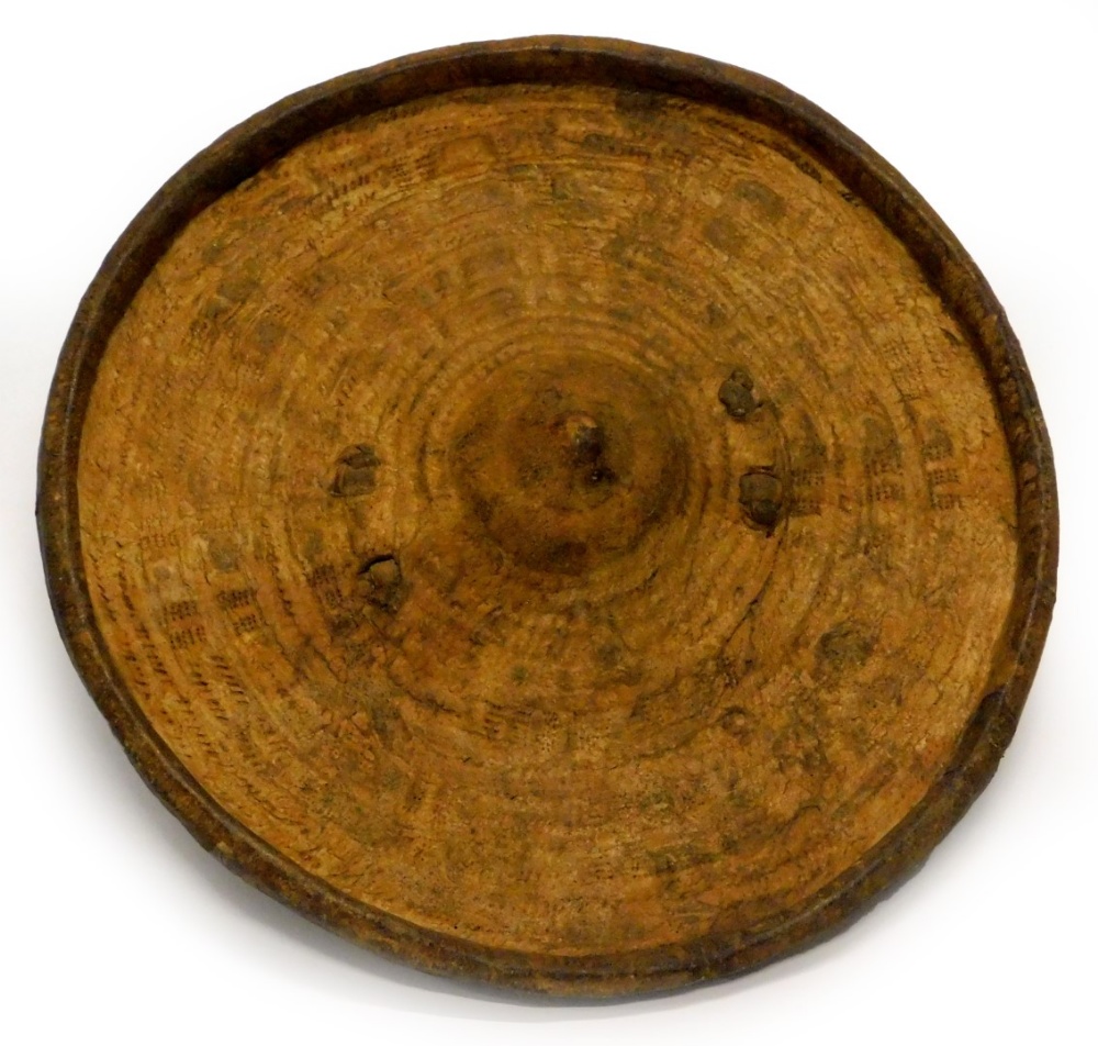 A small African hide circular shield, with geometric decoration ...