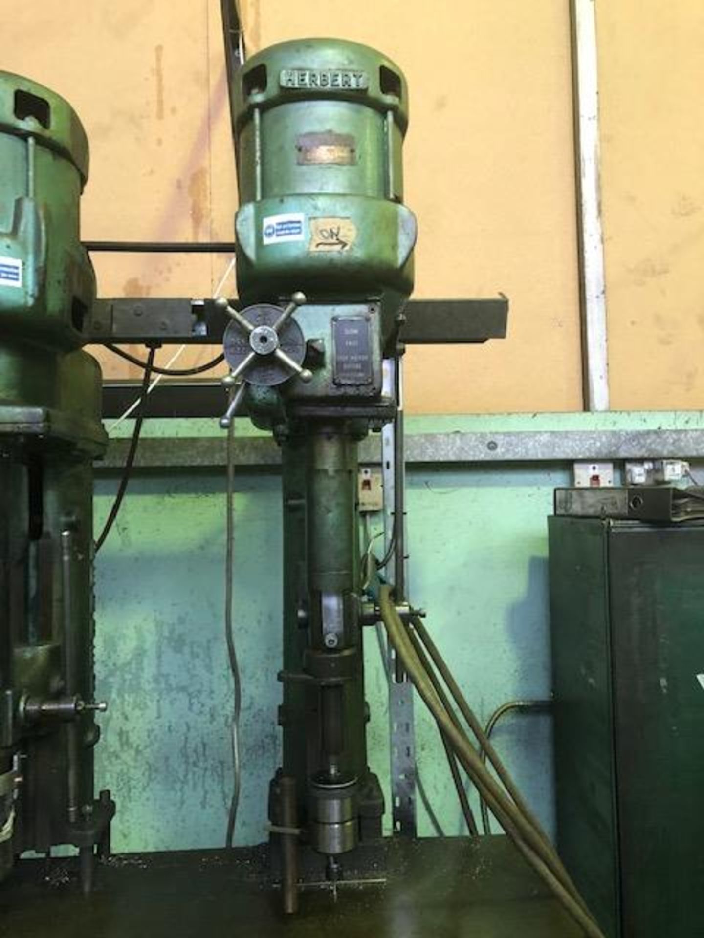 Steel drill bench with 5 Herbert and 1 Meddings overhead drill units