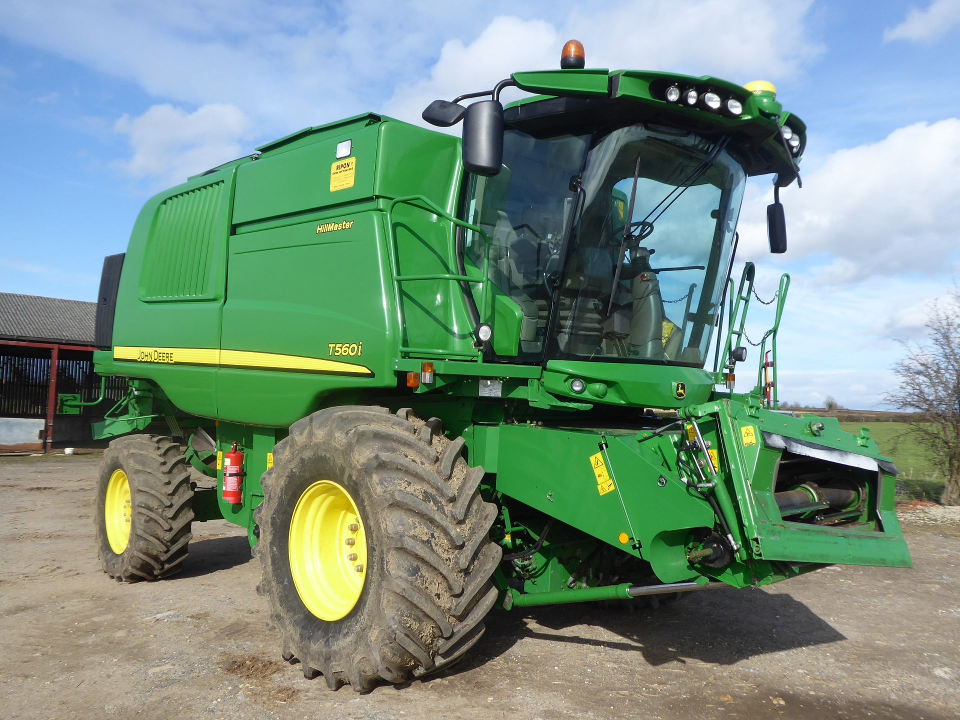 John Deere T560i Hillside combine harvester c/w 625R header and trailer ...