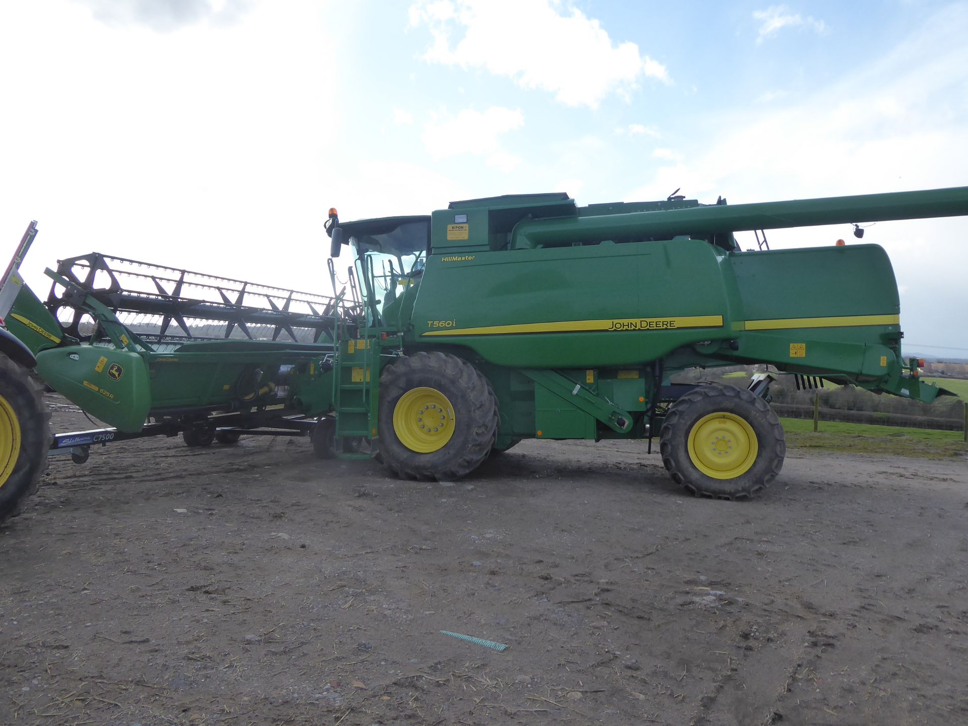 John Deere T560i Hillside combine harvester c/w 625R header and trailer ...