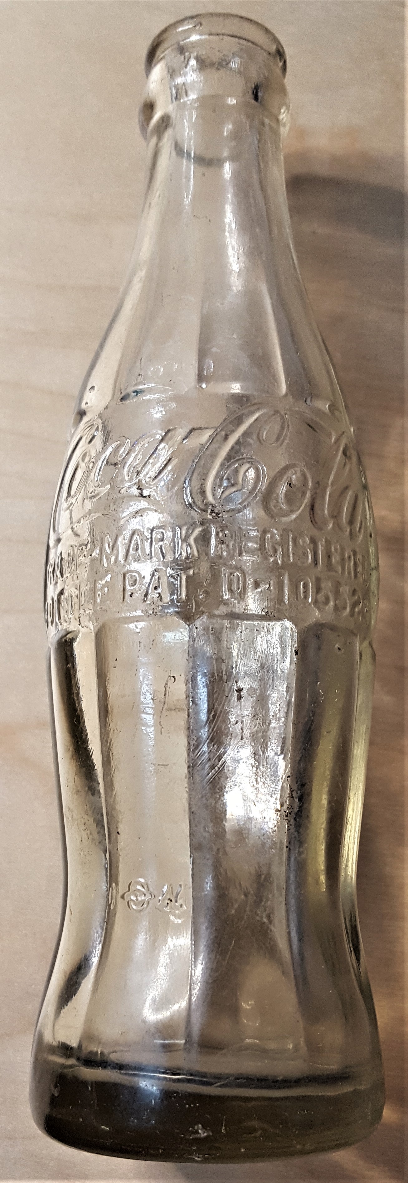 WW2 U.S. Coca-Cola glass bottle dated 1944. The bottle is embossed on ...