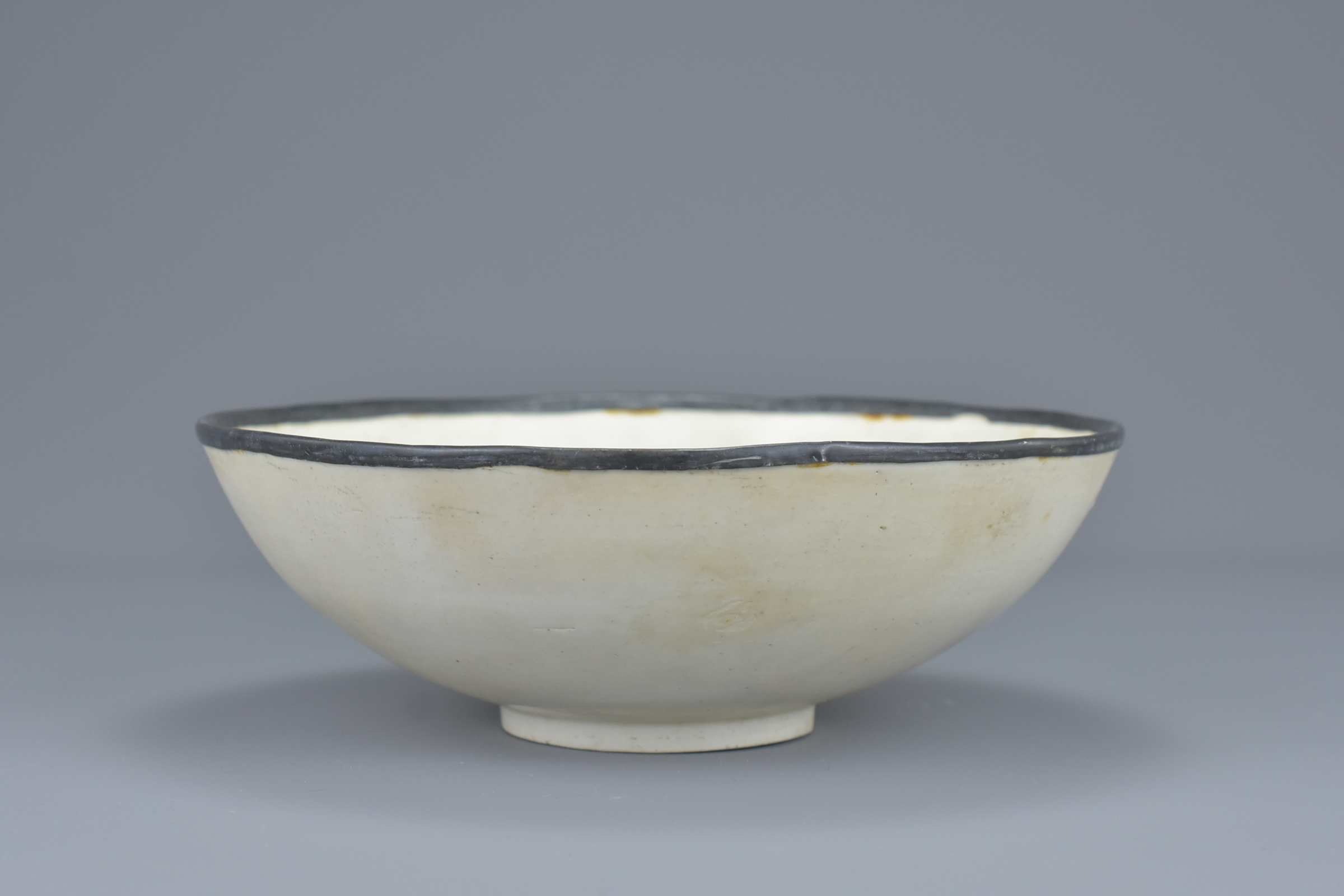 A Chinese Song dynasty (960-1279) white glazed Ding type pottery bowl ...