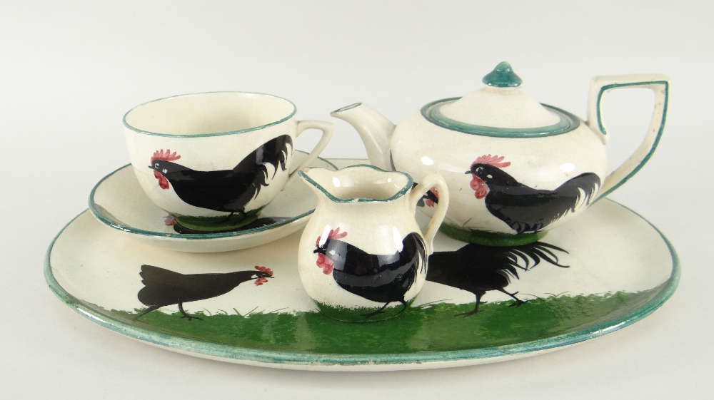 A LLANELLY POTTERY FOUR PIECE CABARET TEA SET painted with Black Cocks ...