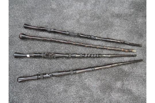 A selection of ethnic tribal walking sticks all hand worked with ...