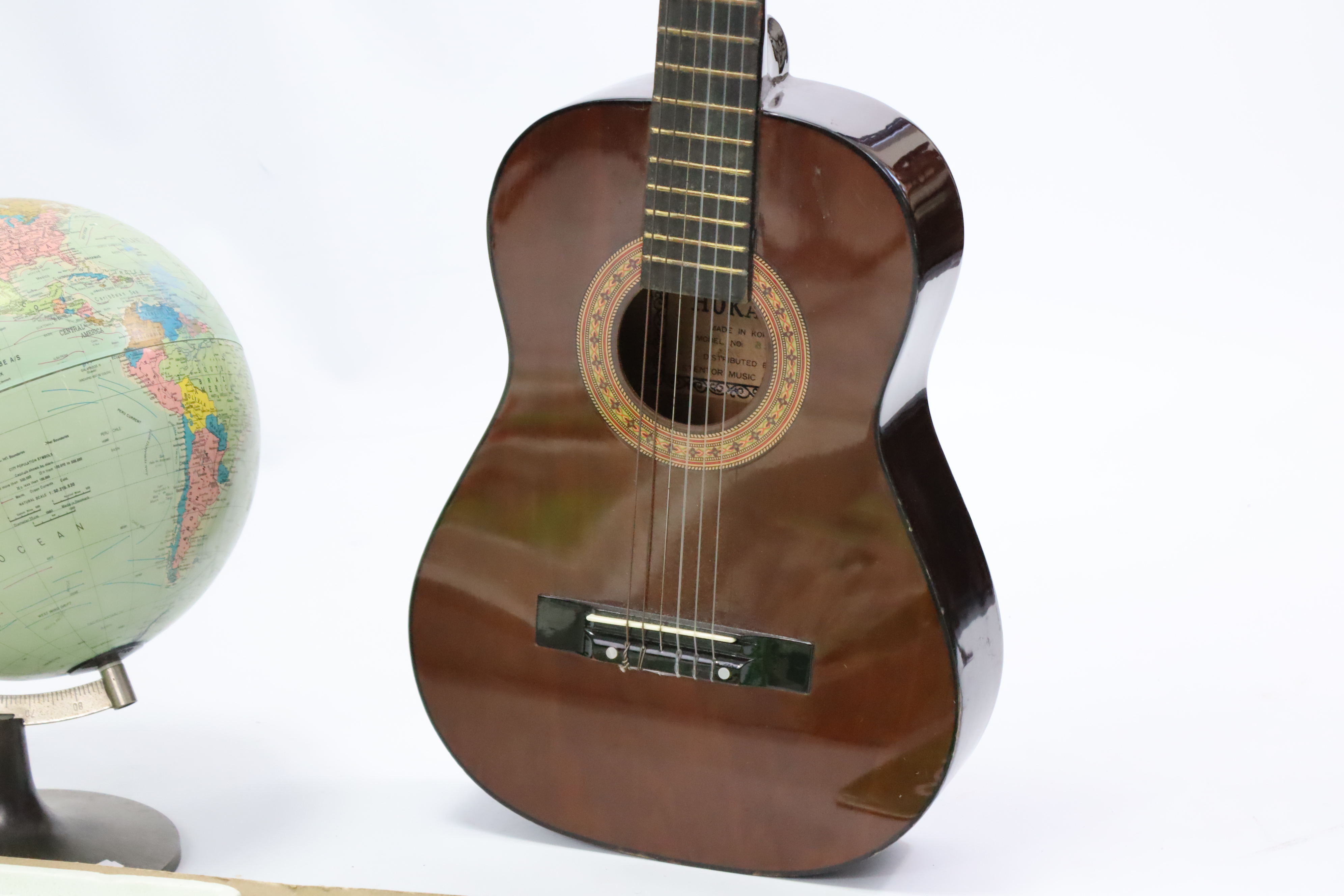 An Hokada six-string acoustic guitar; together with a terrestrial globe ...