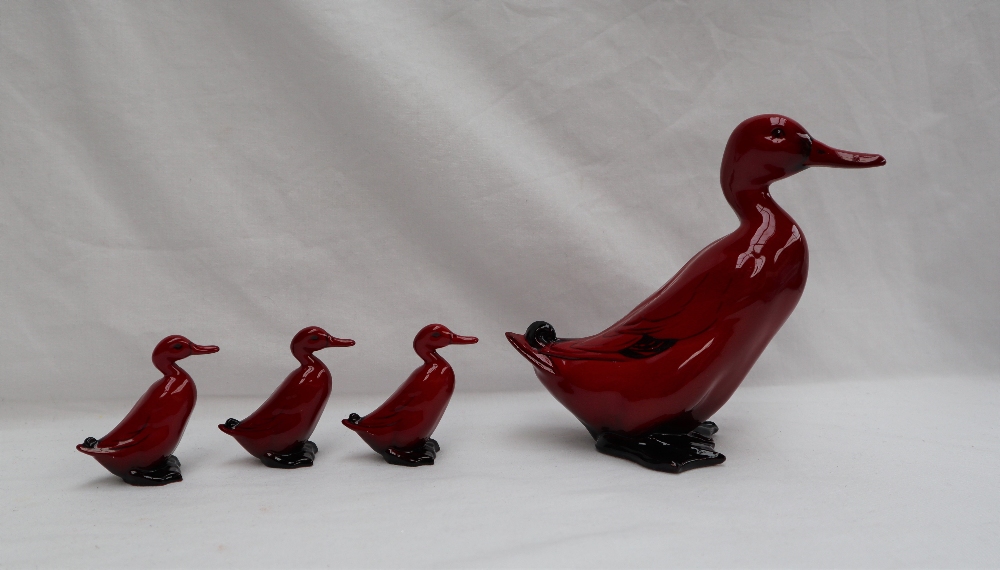 A Royal Doulton flambe duck, together with three small ducks