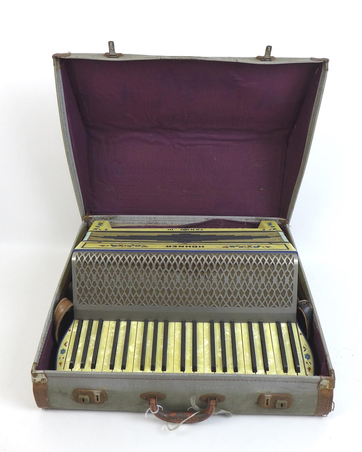 A Hohner Tango III piano accordion with case, and a mandolin banjo with ...