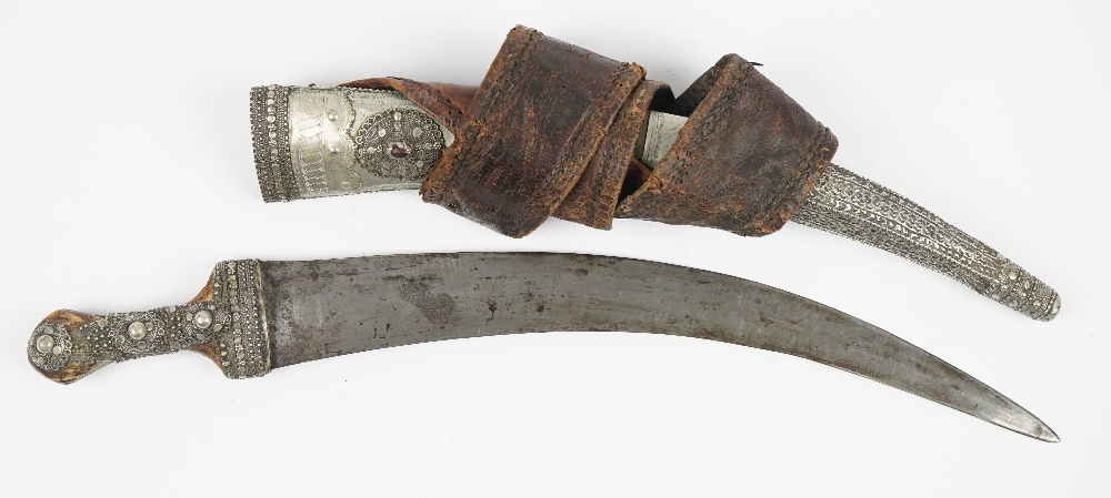 A Saudi Arabian long knife, 19th century, with curved steel blade, 40cm ...