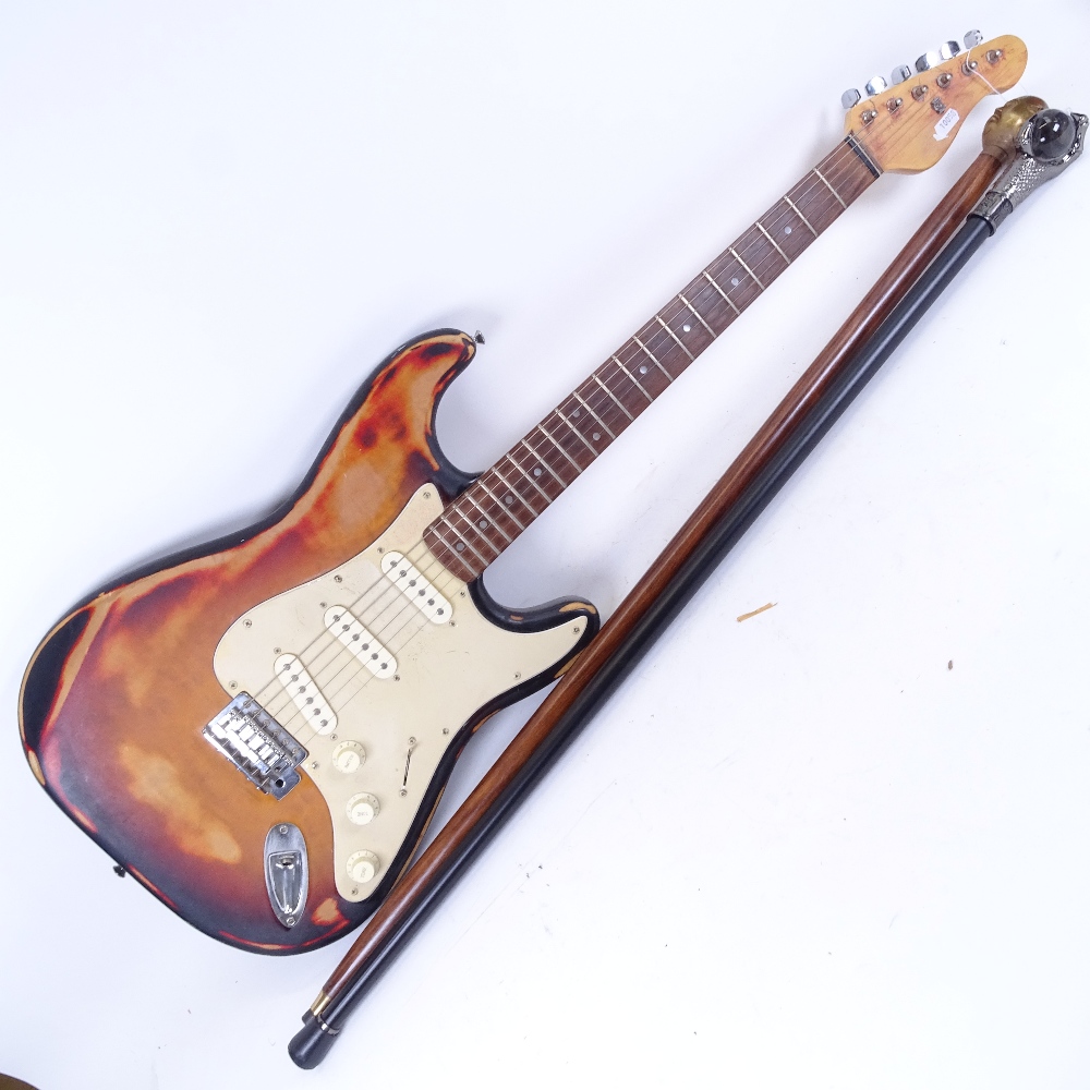 An electric guitar, and 2 modern walking canes (3)