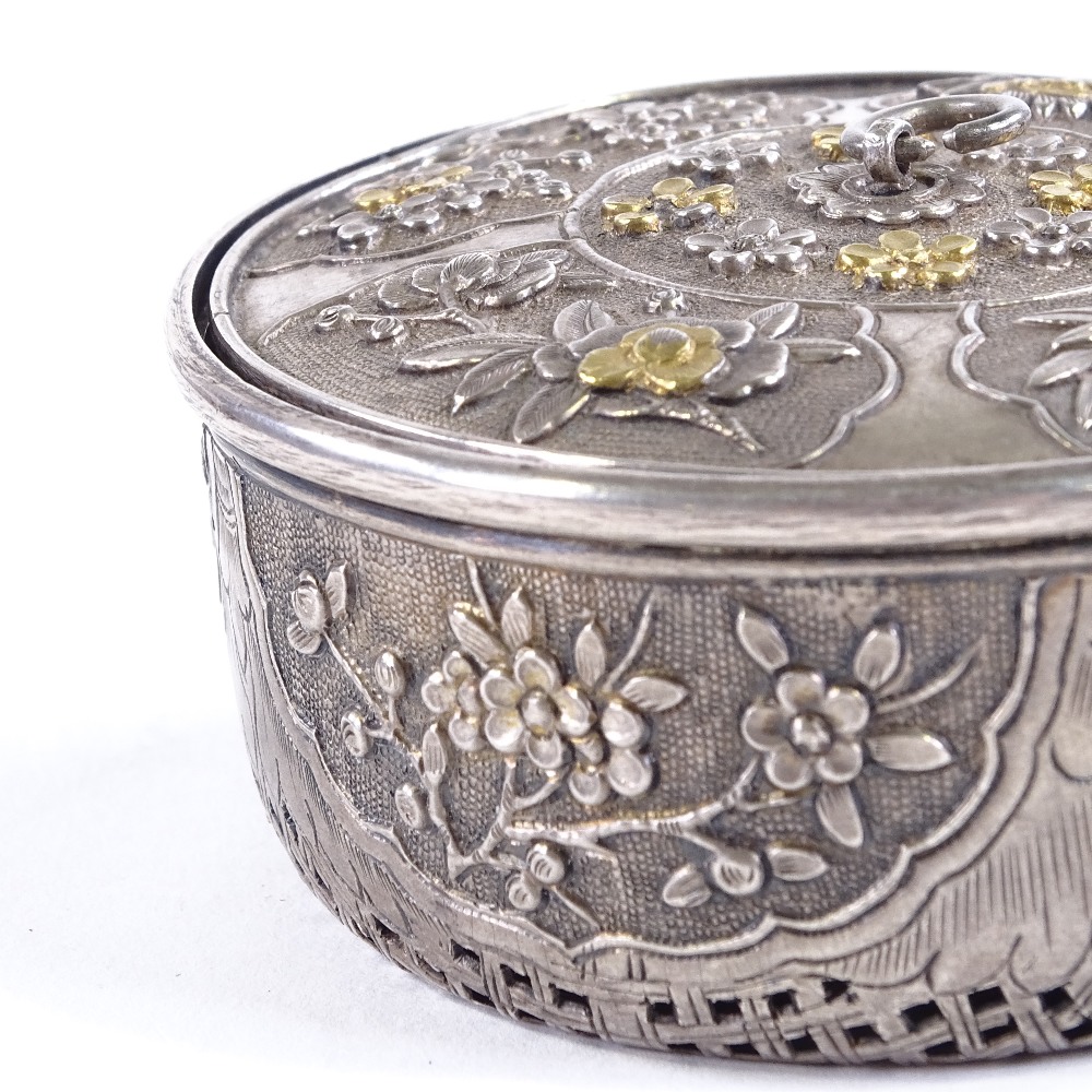 A Chinese unmarked silver cricket cage, circa 1900, parcel gilt relief ...