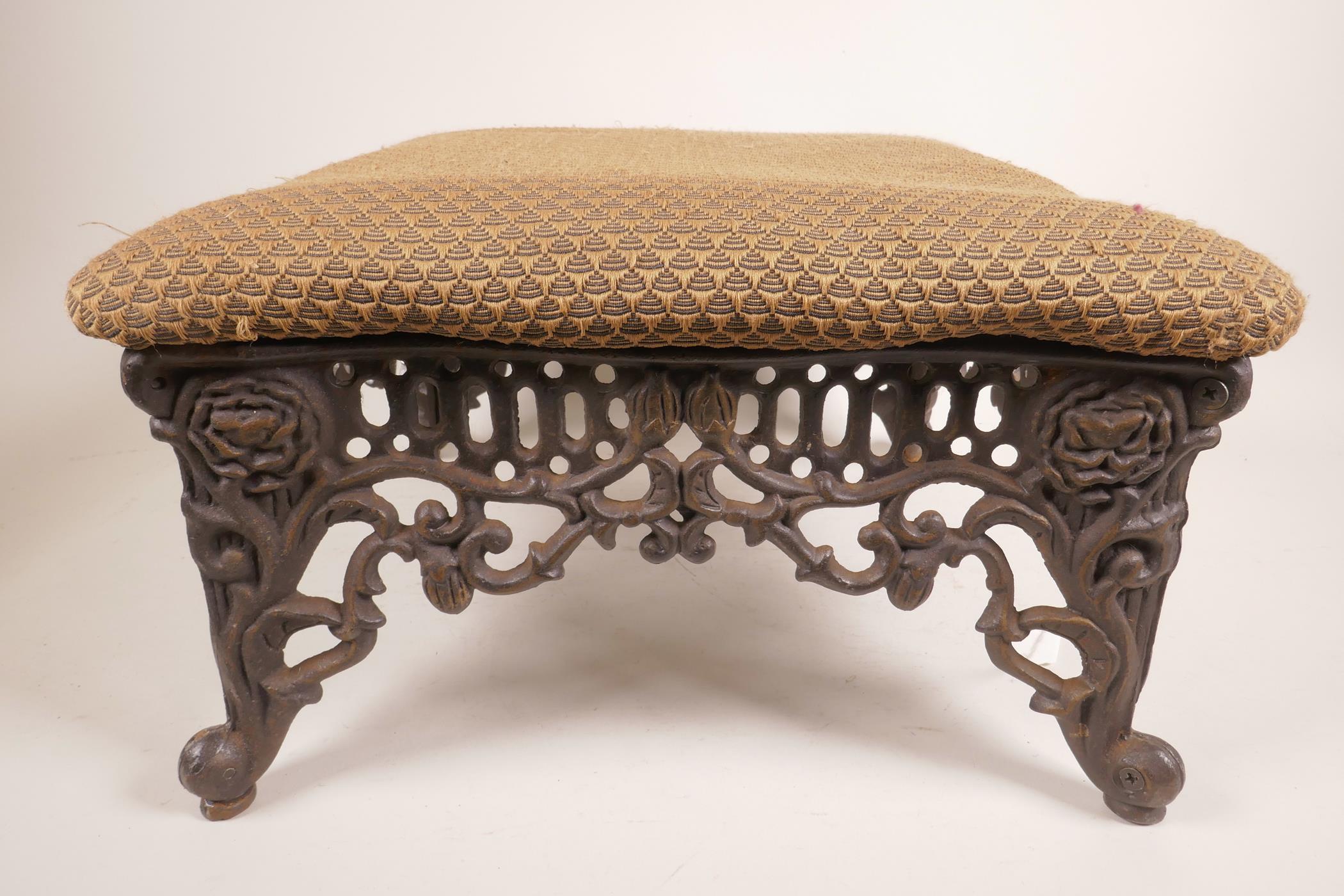 A Victorian wrought iron stool, with a padded seat, 14"