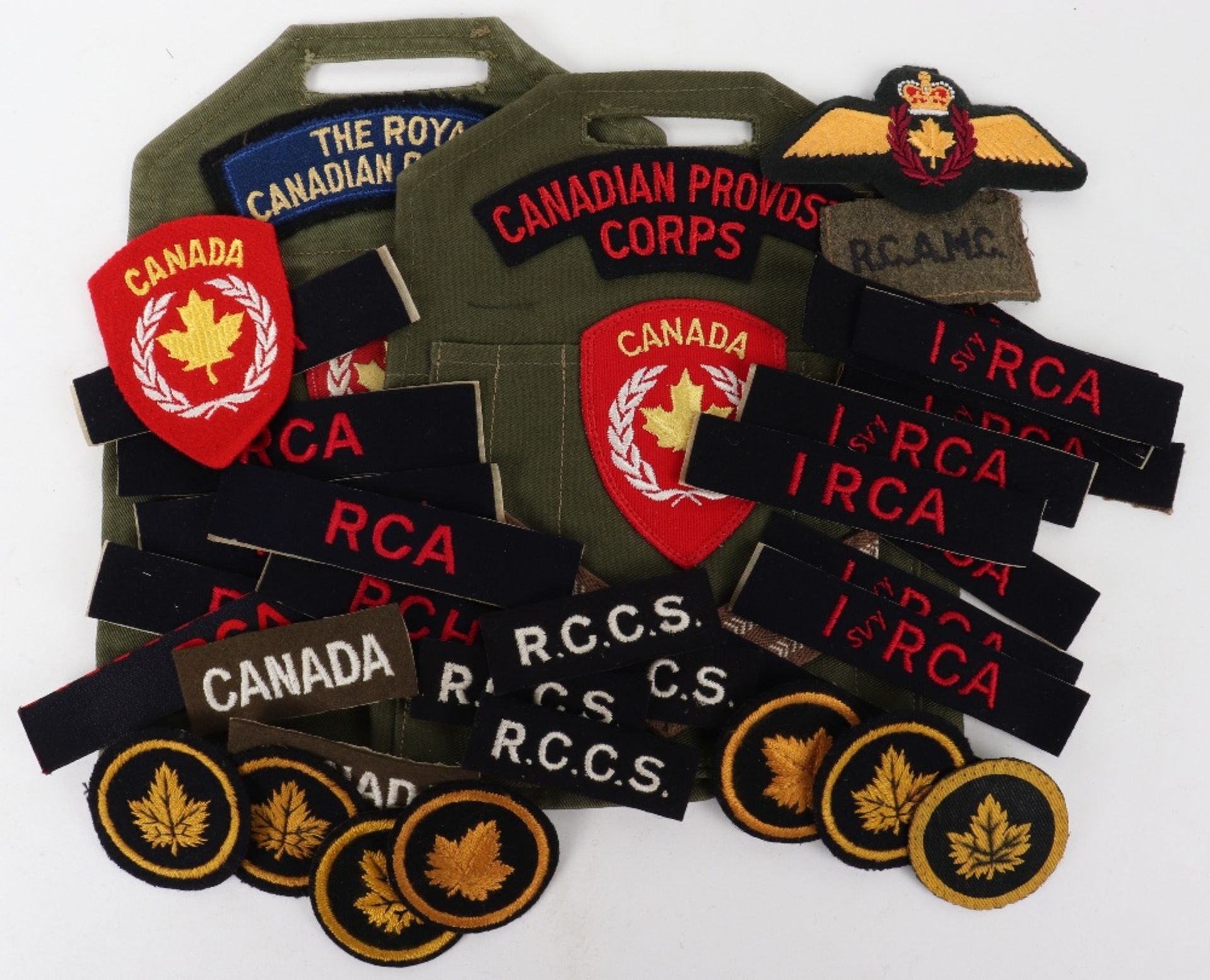 Selection of Canadian Military Badges, two brassards with badges ...