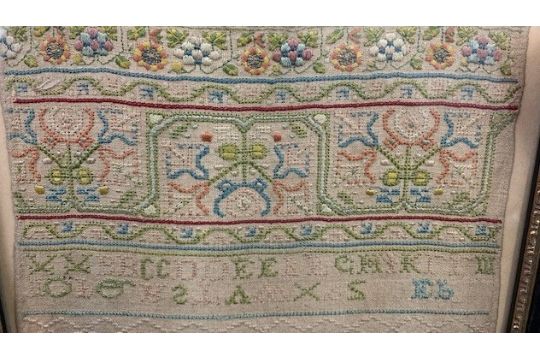 A late 17th century needlework band sampler, the central band depicting ...