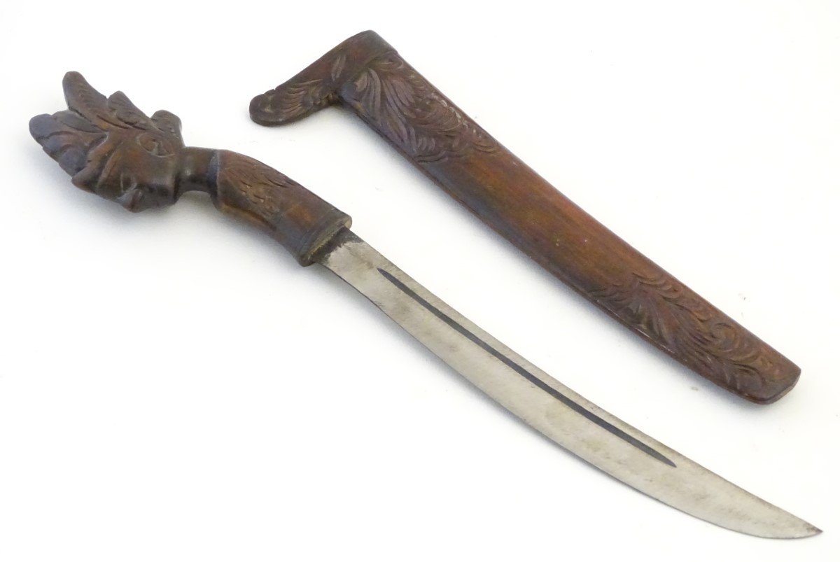 Ethnographic / Native / Tribal : A tribal dagger with a wooden handle ...