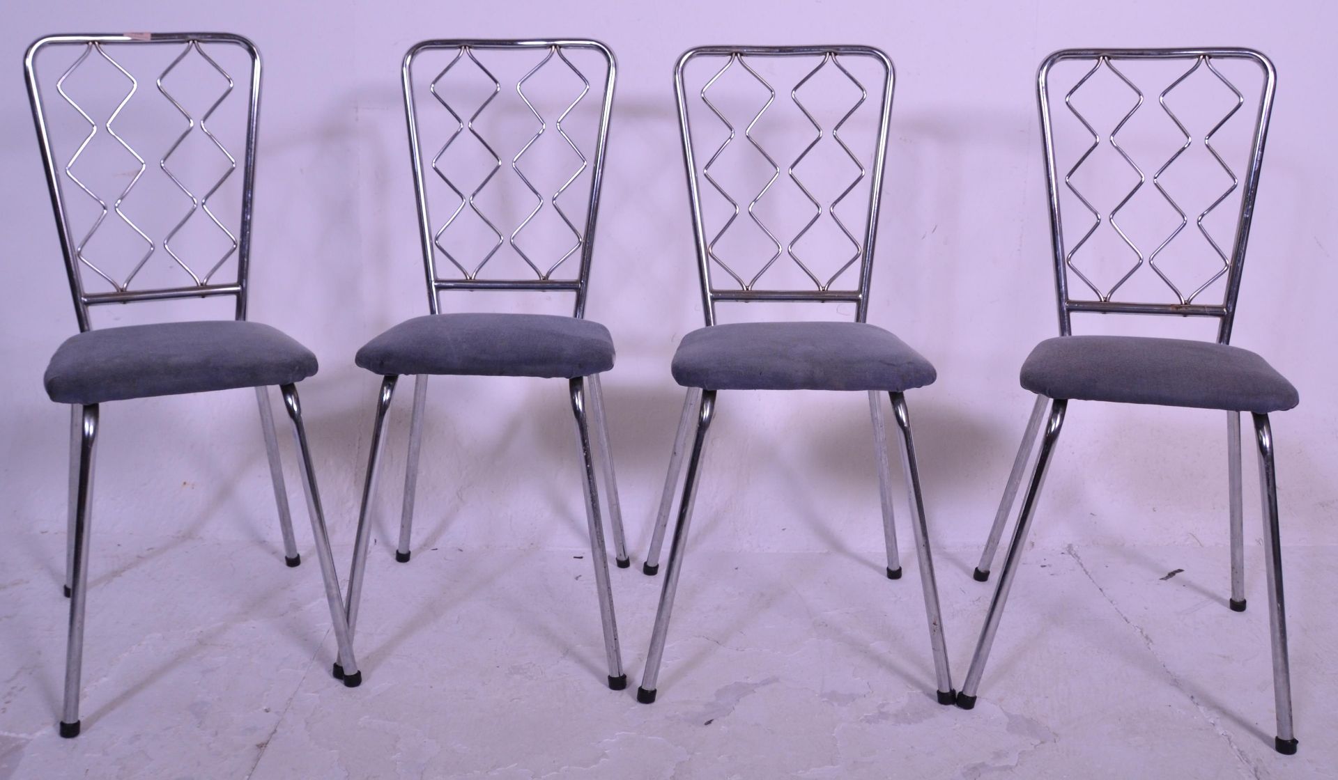 A set of 4 mid century retro chrome tubular metal dining chairs. Raised ...