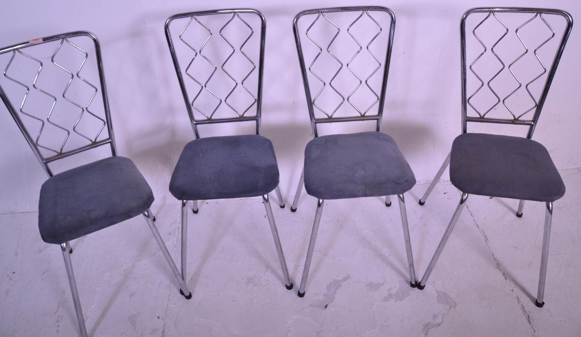 A set of 4 mid century retro chrome tubular metal dining chairs. Raised ...