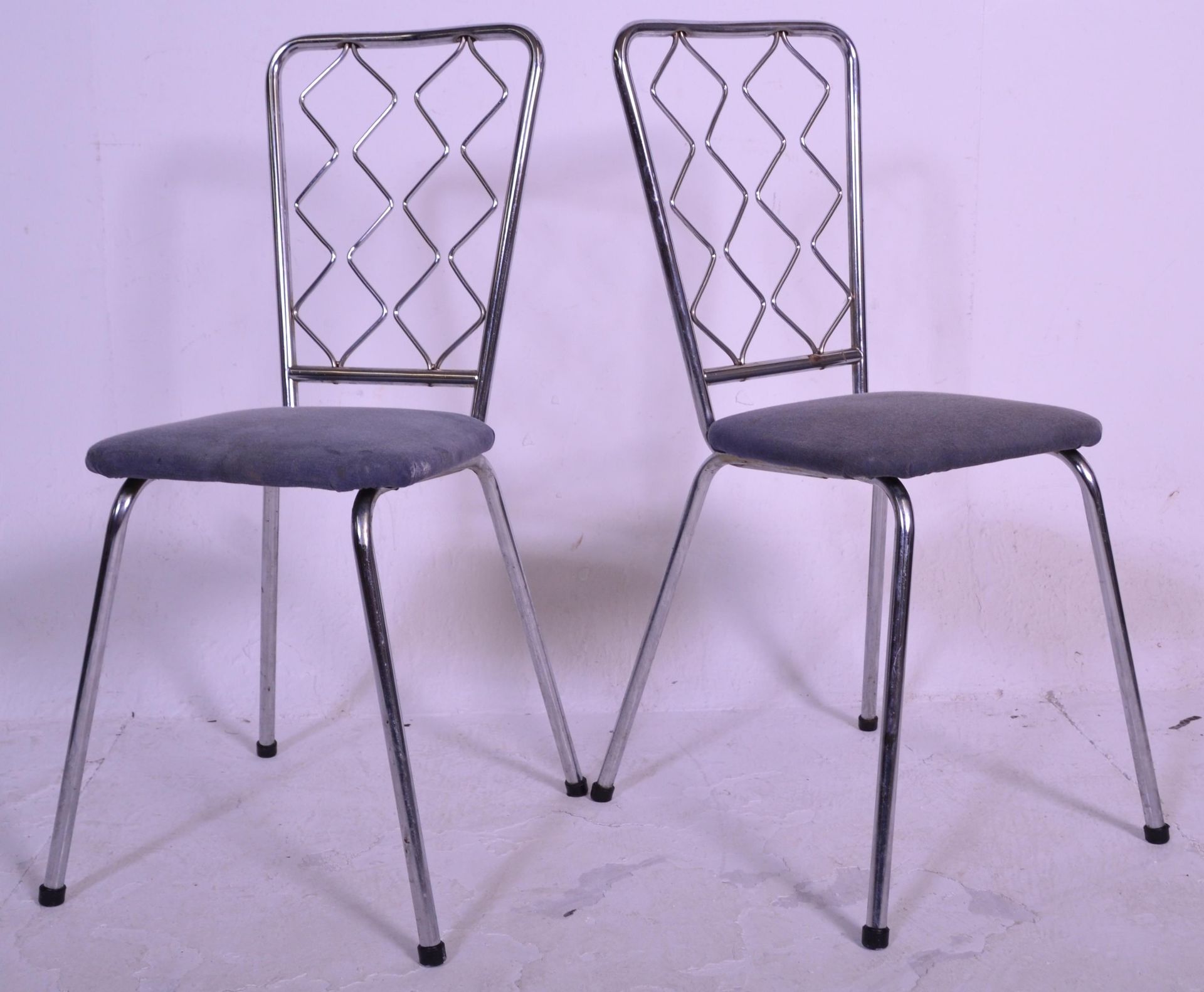 A set of 4 mid century retro chrome tubular metal dining chairs. Raised ...