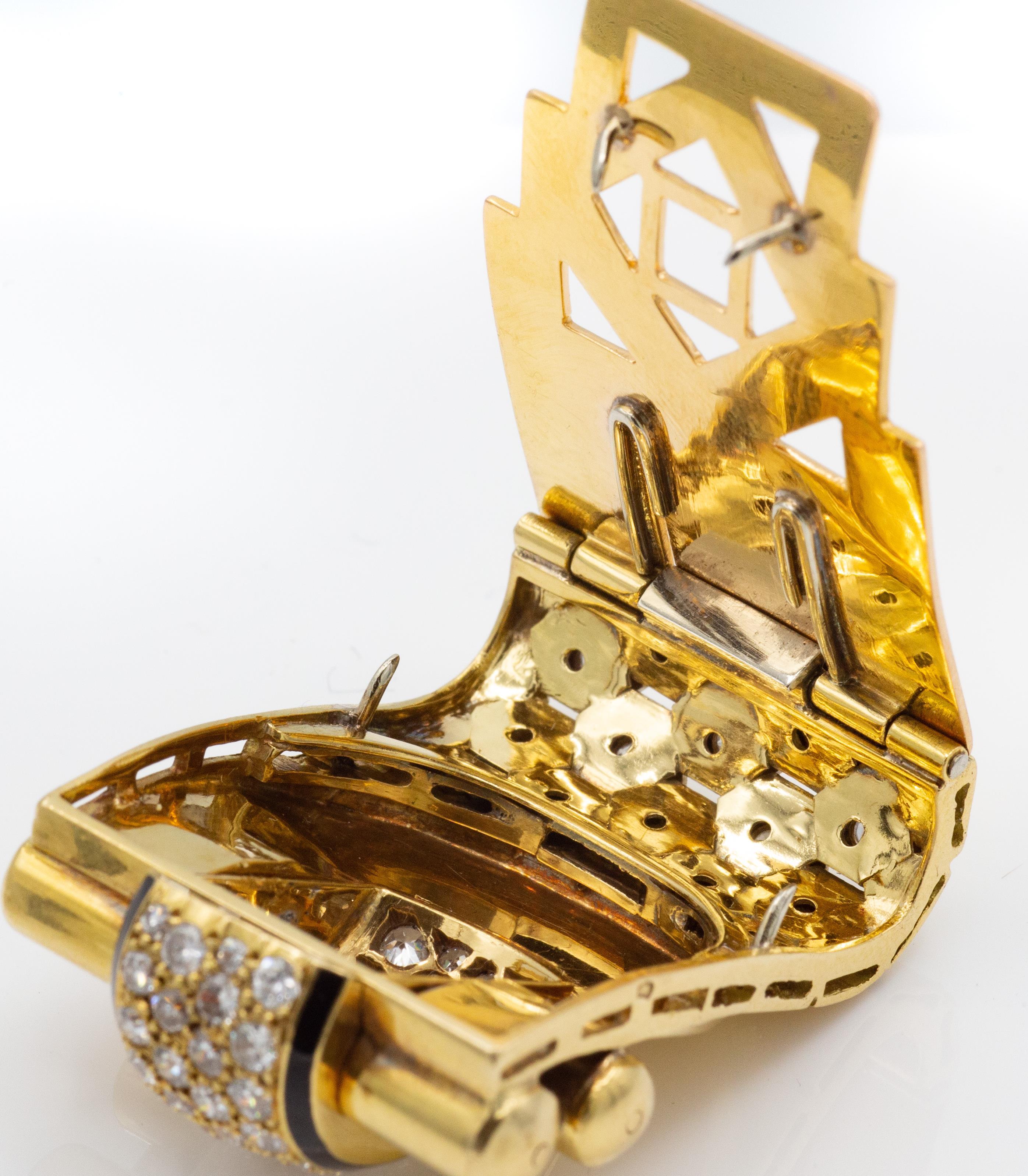An 18ct yellow gold dress clip of beehive hexagon construction set with round brilliant cut diamo