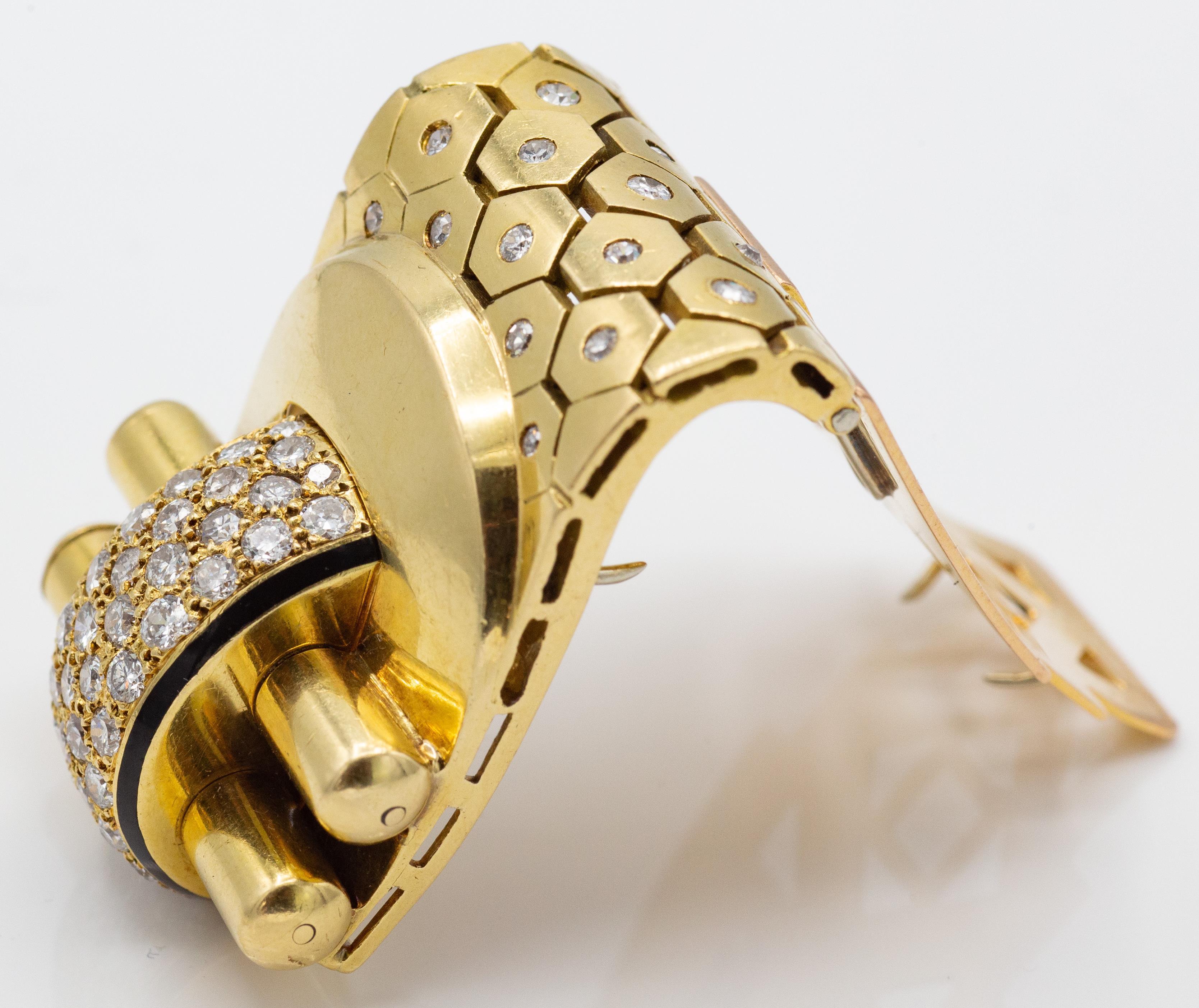 An 18ct yellow gold dress clip of beehive hexagon construction set with round brilliant cut diamo