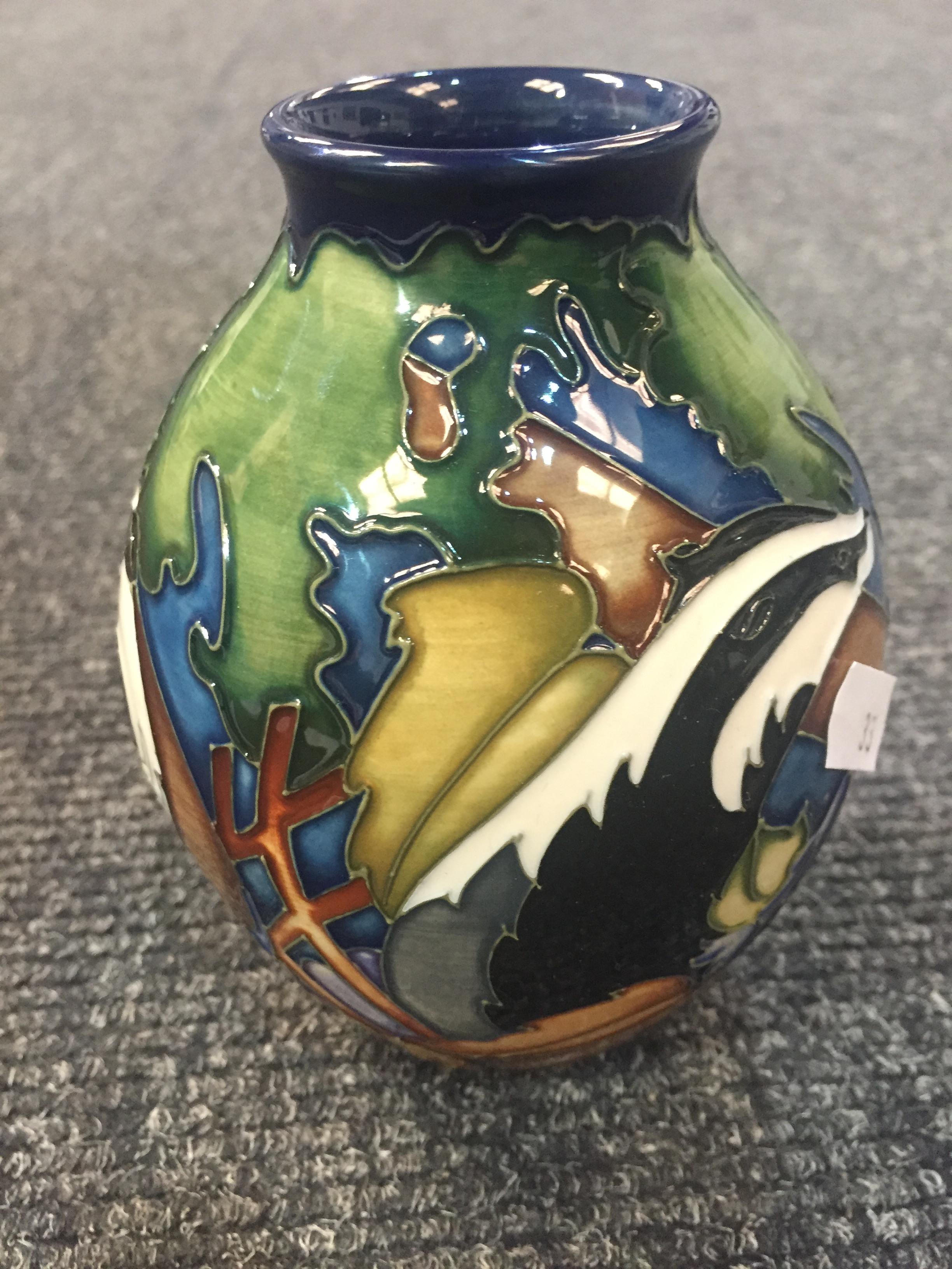 A Moorcroft Pottery vase decorated in The Sett pattern designed by ...