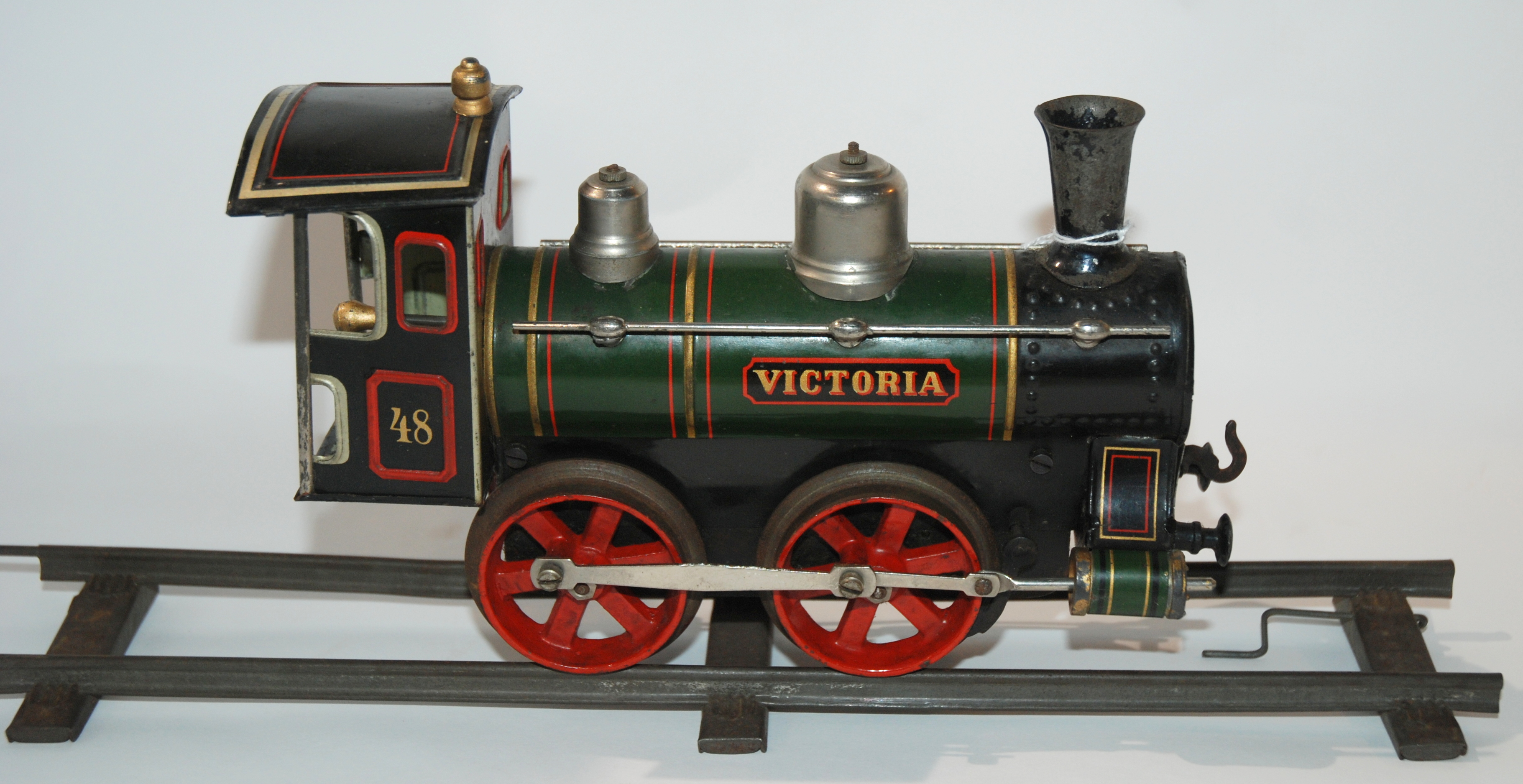 A vintage Bing tinplate clockwork locomotive with tender, two coaches ...