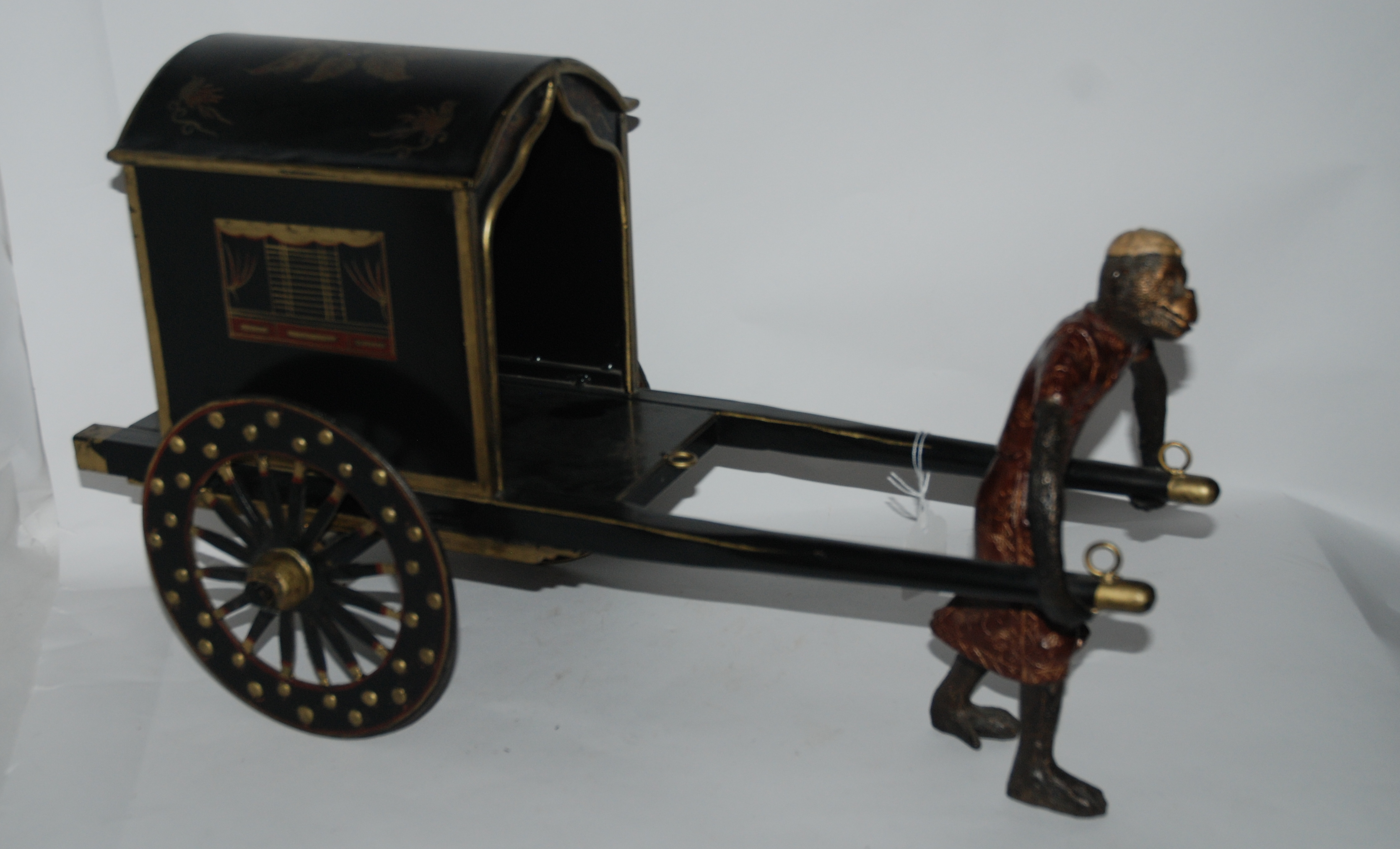 A 20th Century metal model of a monkey pulling a cart, 55cm long ...