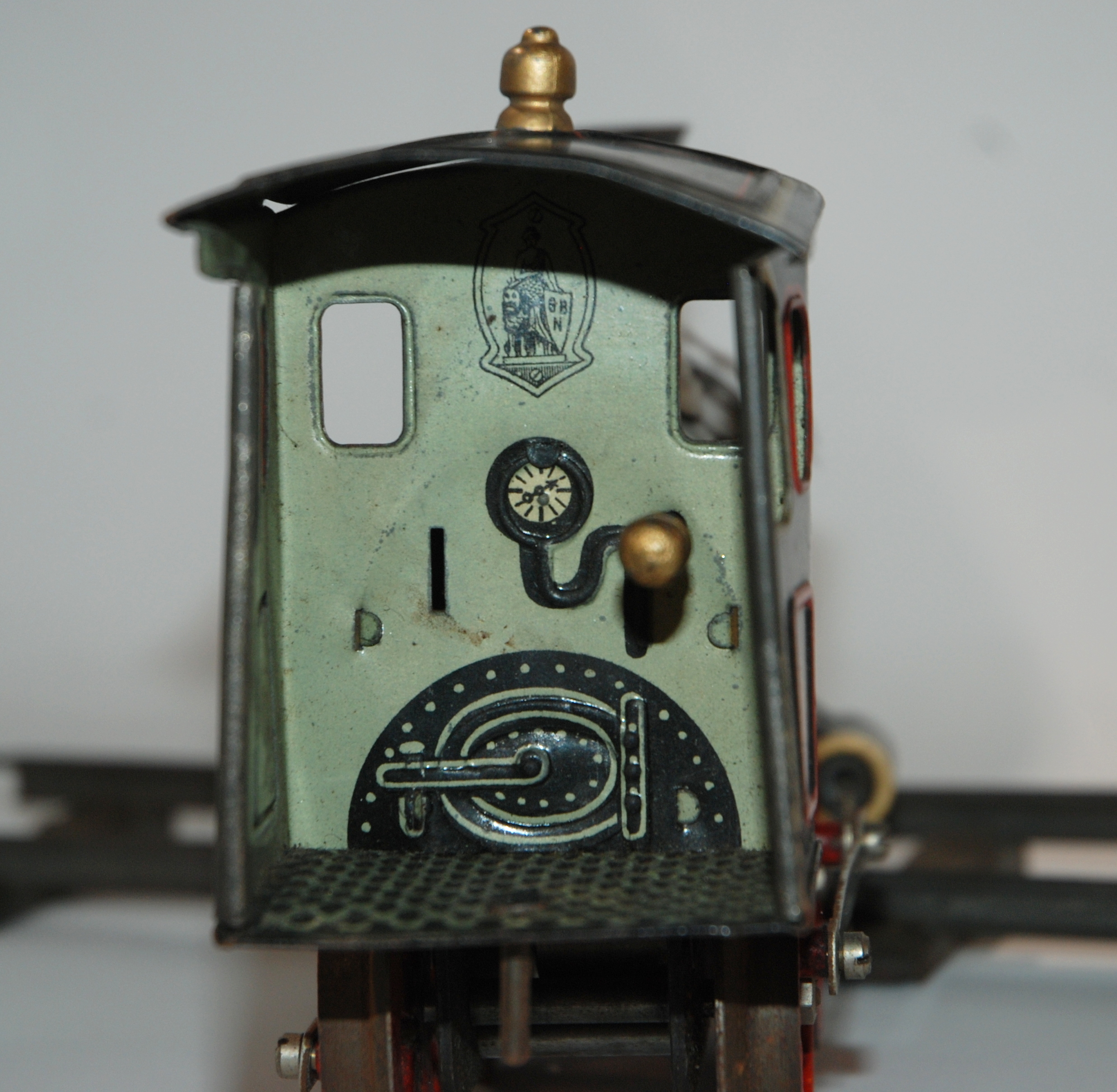 A vintage Bing tinplate clockwork locomotive with tender, two coaches ...