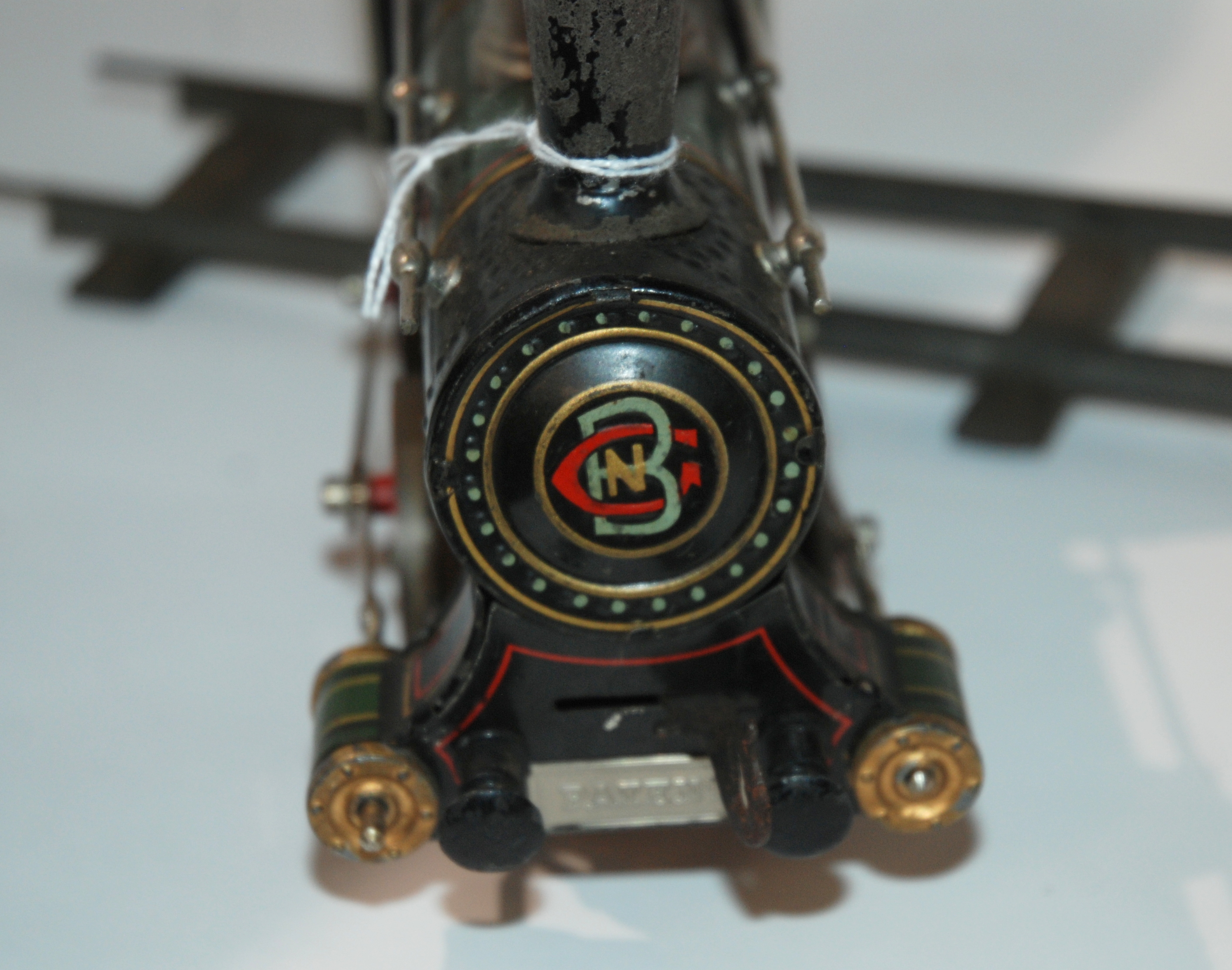 A vintage Bing tinplate clockwork locomotive with tender, two coaches ...