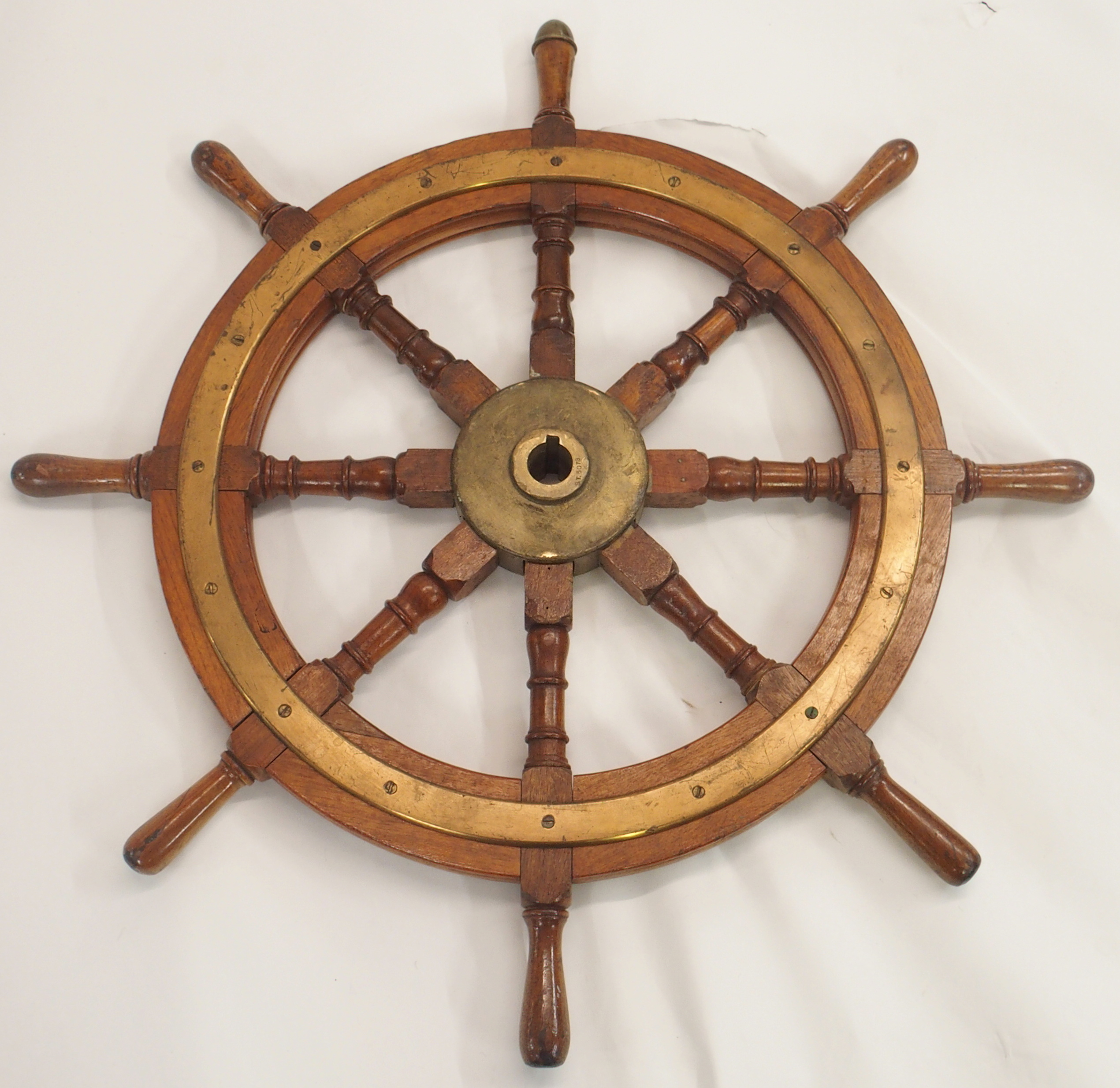 AN OAK AND BRASS MOUNTED SHIPS TELEMOTOR WHEEL WITH EIGHT SPINDLES the ...